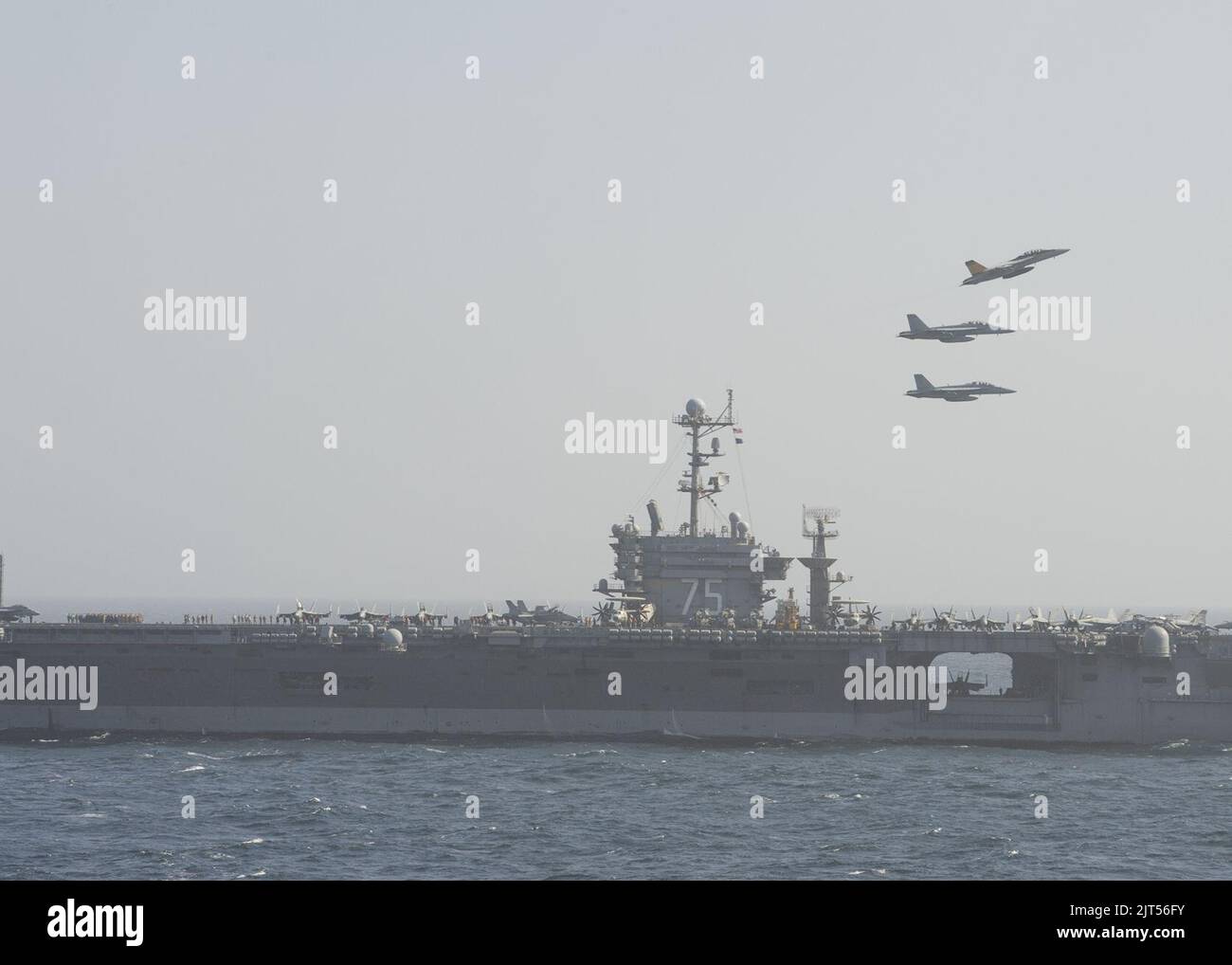 U.S. Navy Cmdr. Jeremy T. Andrew, top, the outgoing commanding officer ...