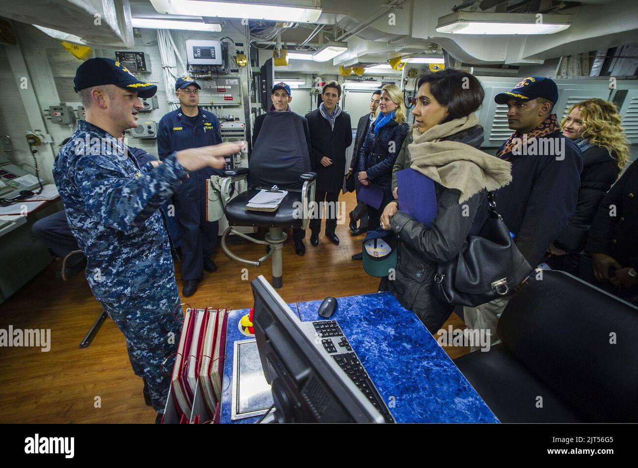 U.S. Navy Cmdr. Jonathan Schmitz, left, the commanding officer of the ...