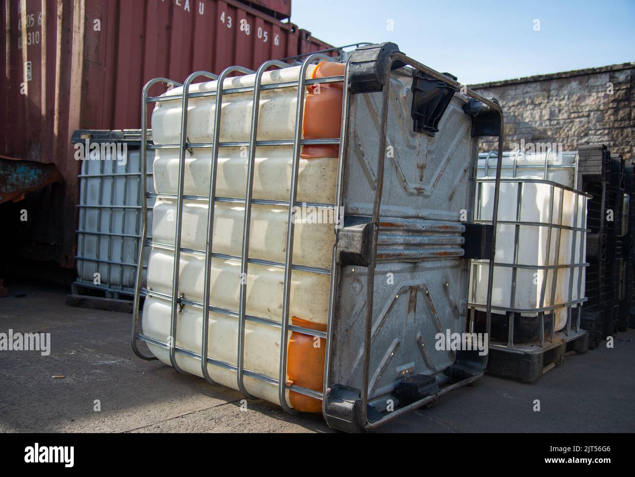 Heavily used old white intermediate bulk container or IBC plastic tank ...