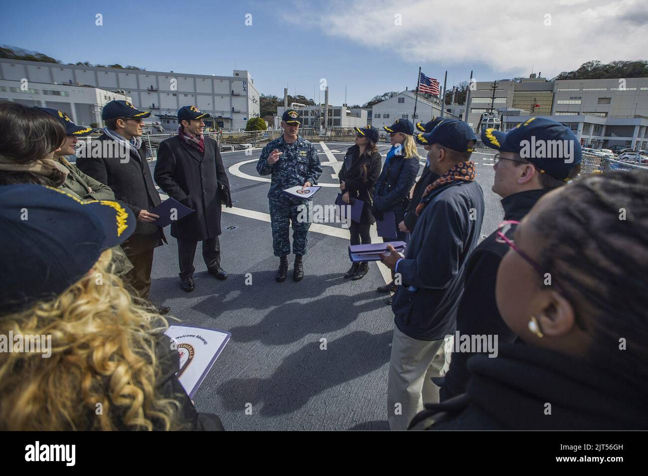 U.S. Navy Cmdr. Jonathan Schmitz, center, the commanding officer of the ...