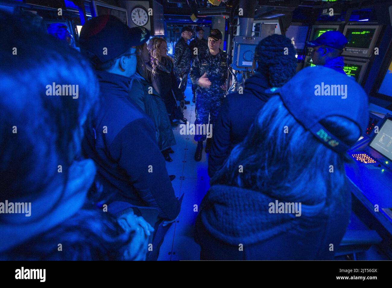 U.S. Navy Cmdr. Jonathan Schmitz, center, the commanding officer of the ...