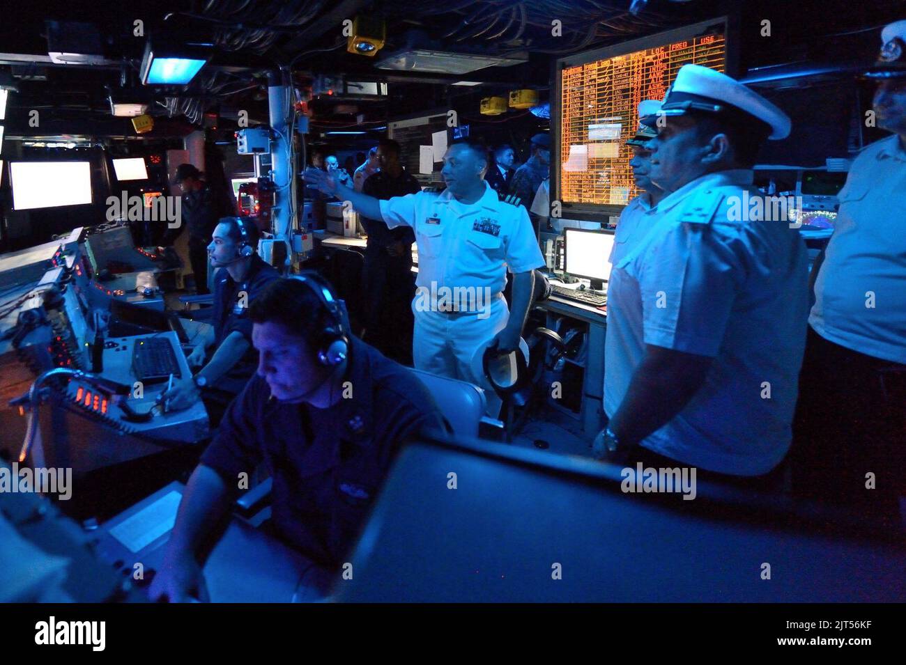 U.S. Navy Cmdr. Tadd Gorman, center, the commanding officer of the ...