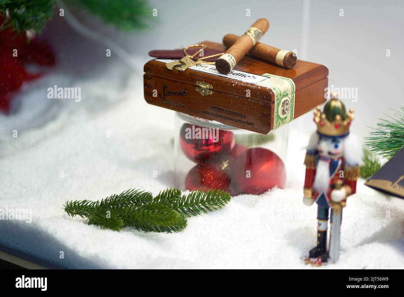 Stuttgart, Germany - December 31, 2021: Wooden cigar box behind Christmas decorated shop window ...