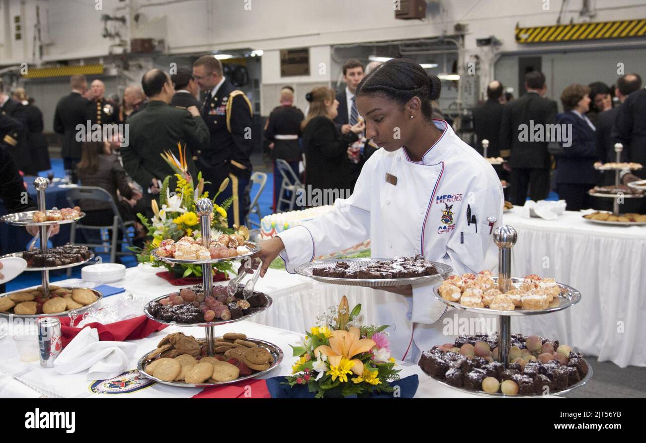 U.S. Navy Culinary Specialist Seaman Recruit restocks desserts during a ...