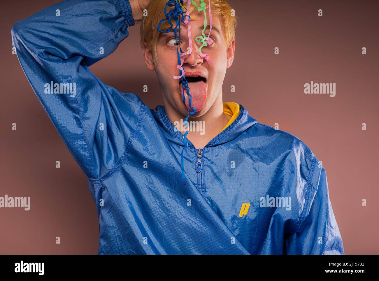 Young blonde boy is making crazy faces while dressed all in blue Stock ...