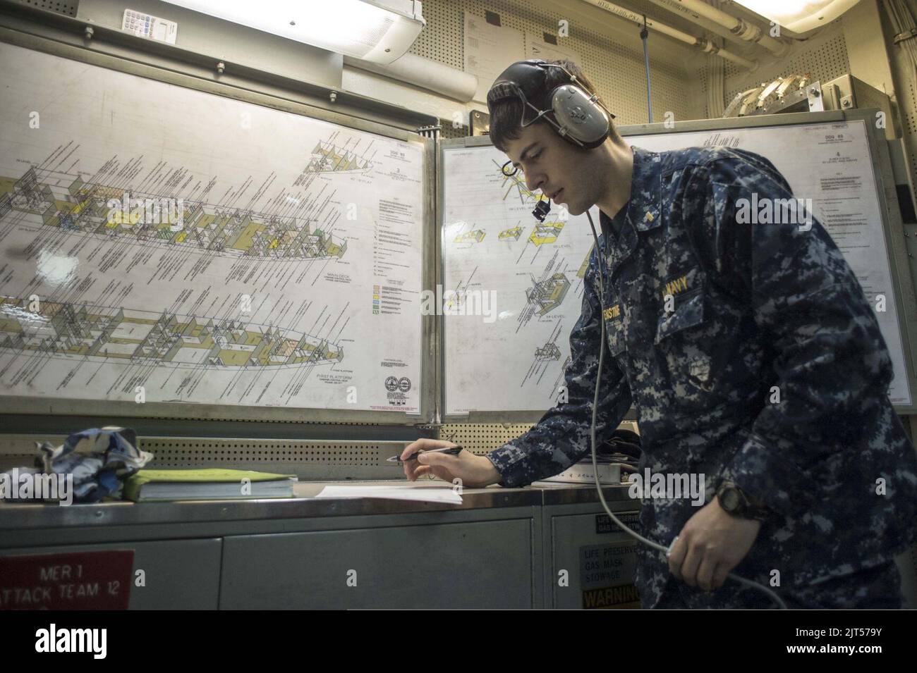 U.S. Navy Ensign relays simulated casualty information from a central ...