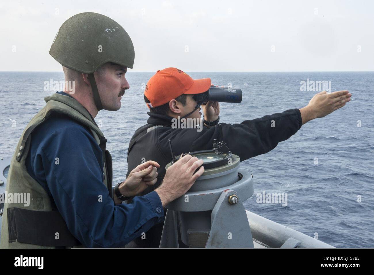 U.S. Navy Ensign and Lt. j.g. both assigned to the amphibious transport ...