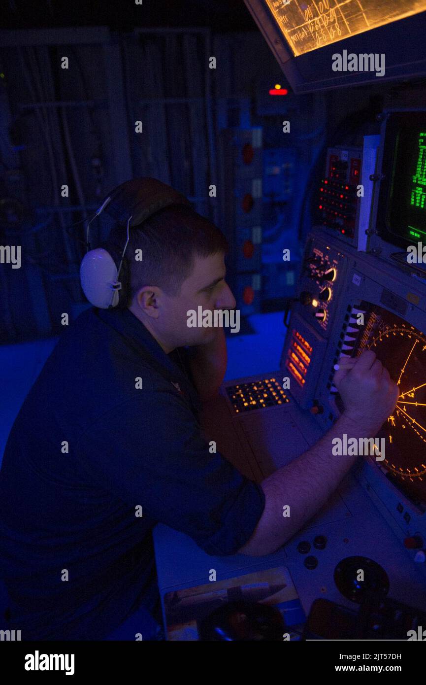 U.S. Navy Fire Controlman 2nd Class stands watch as the radar systems ...