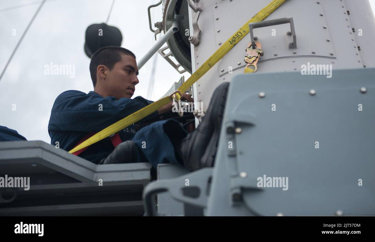 U.S. Navy Fire Controlman 3rd Class conducts routine maintenance on a ...