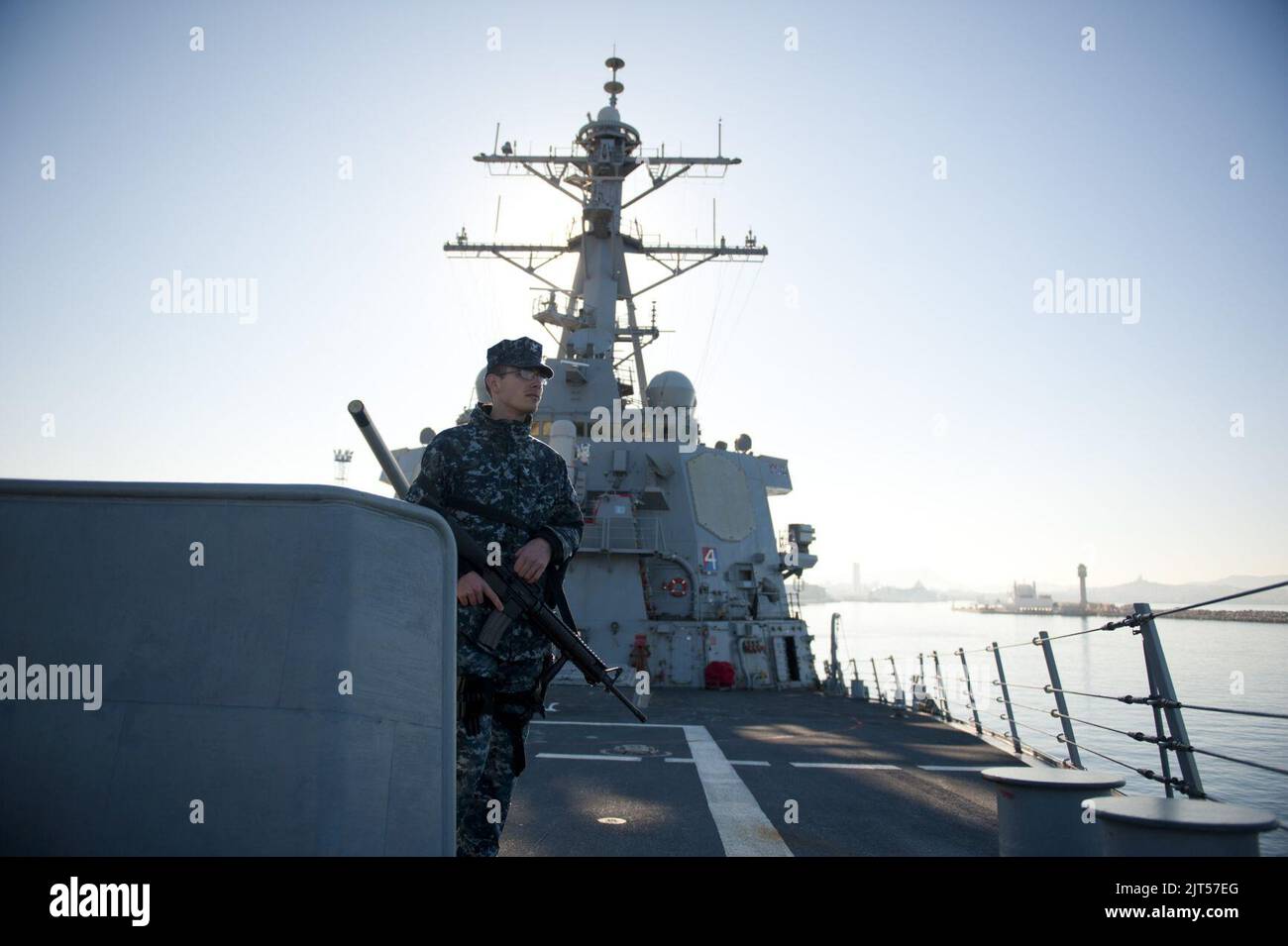 U.S. Navy Fire Controlman 2nd Class scans the perimeter of the guided ...