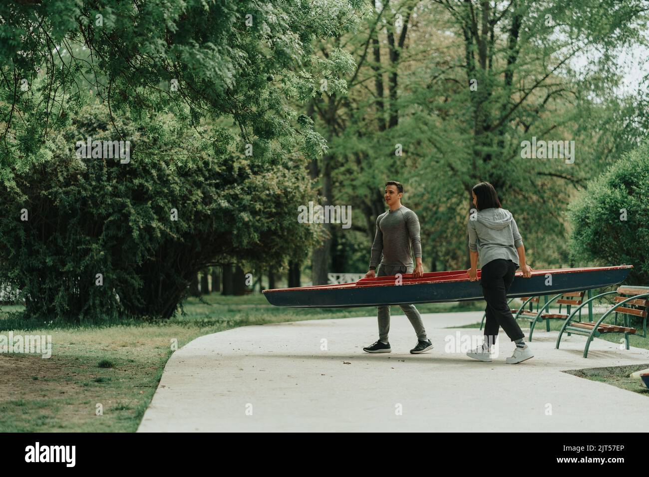 Beautiful couple carrying the kayak while walking in the park Stock ...