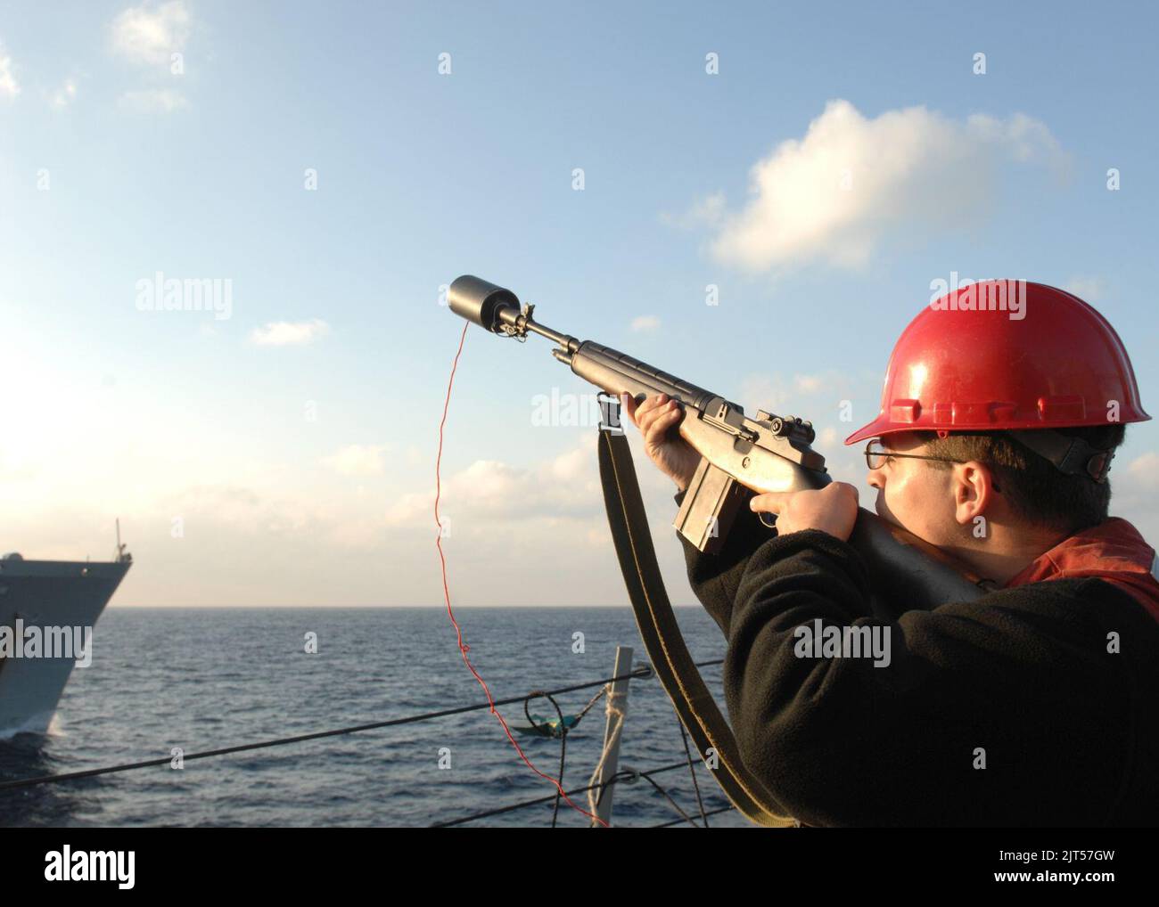 U.S. Navy Gunner's mate 1st Class prepares to fire a shot line from the ...