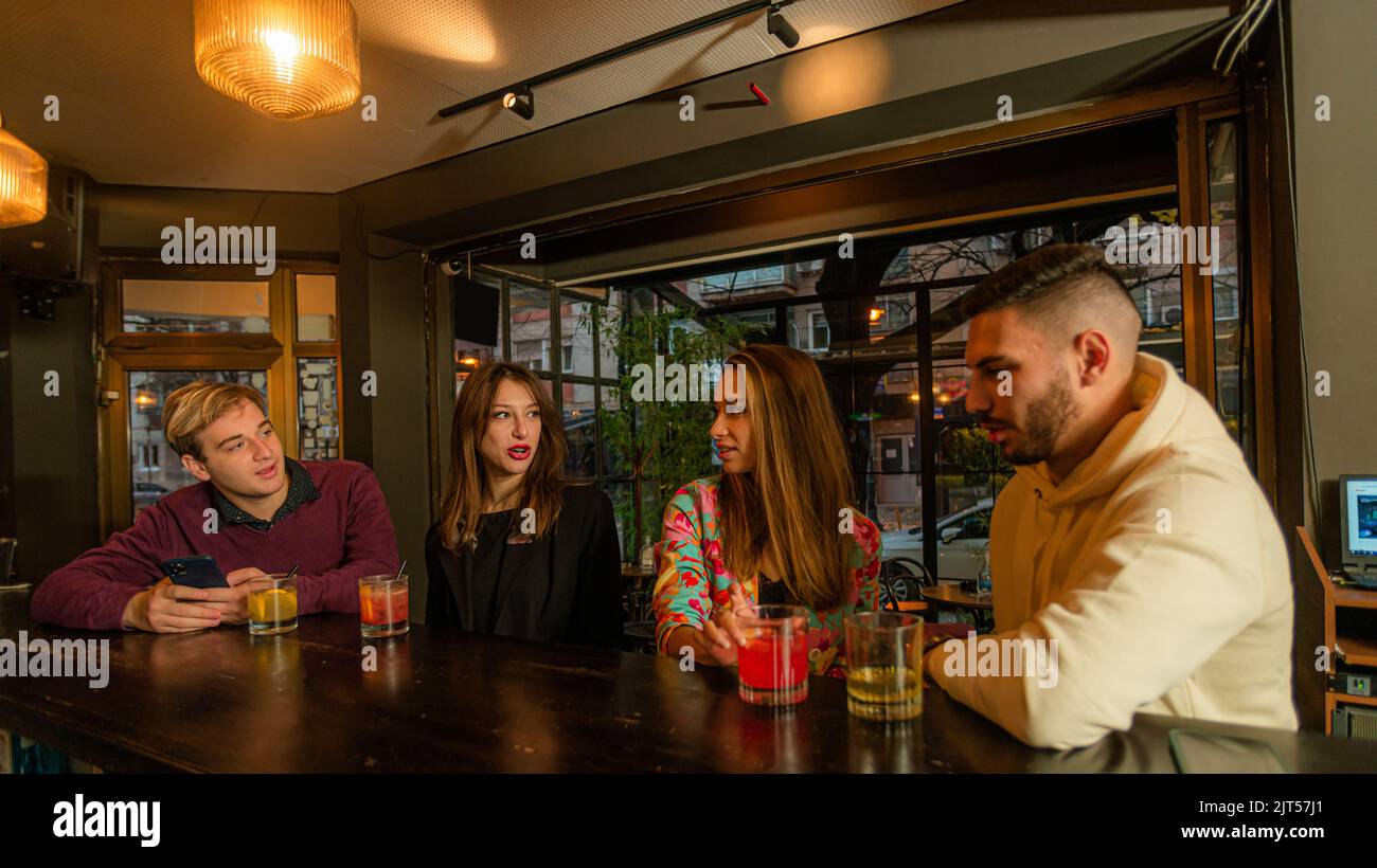 Two amazing and beautiful couples are having a conversation with each ...