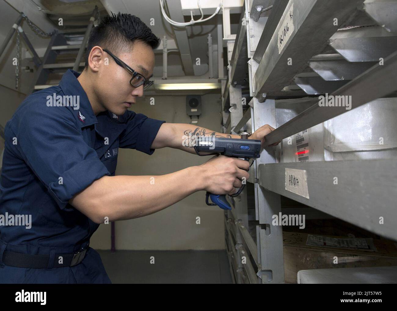 U.S. Navy Logistics Specialist 3rd Class scans repairable parts for ...