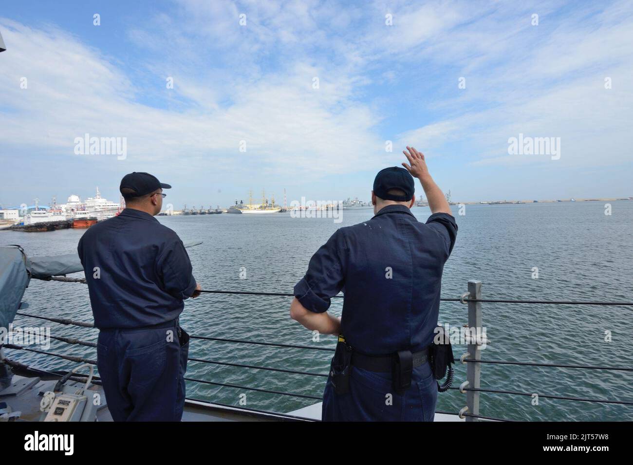 U.S. Navy Logistics Specialist 2nd Class right, waves goodbye aboard ...