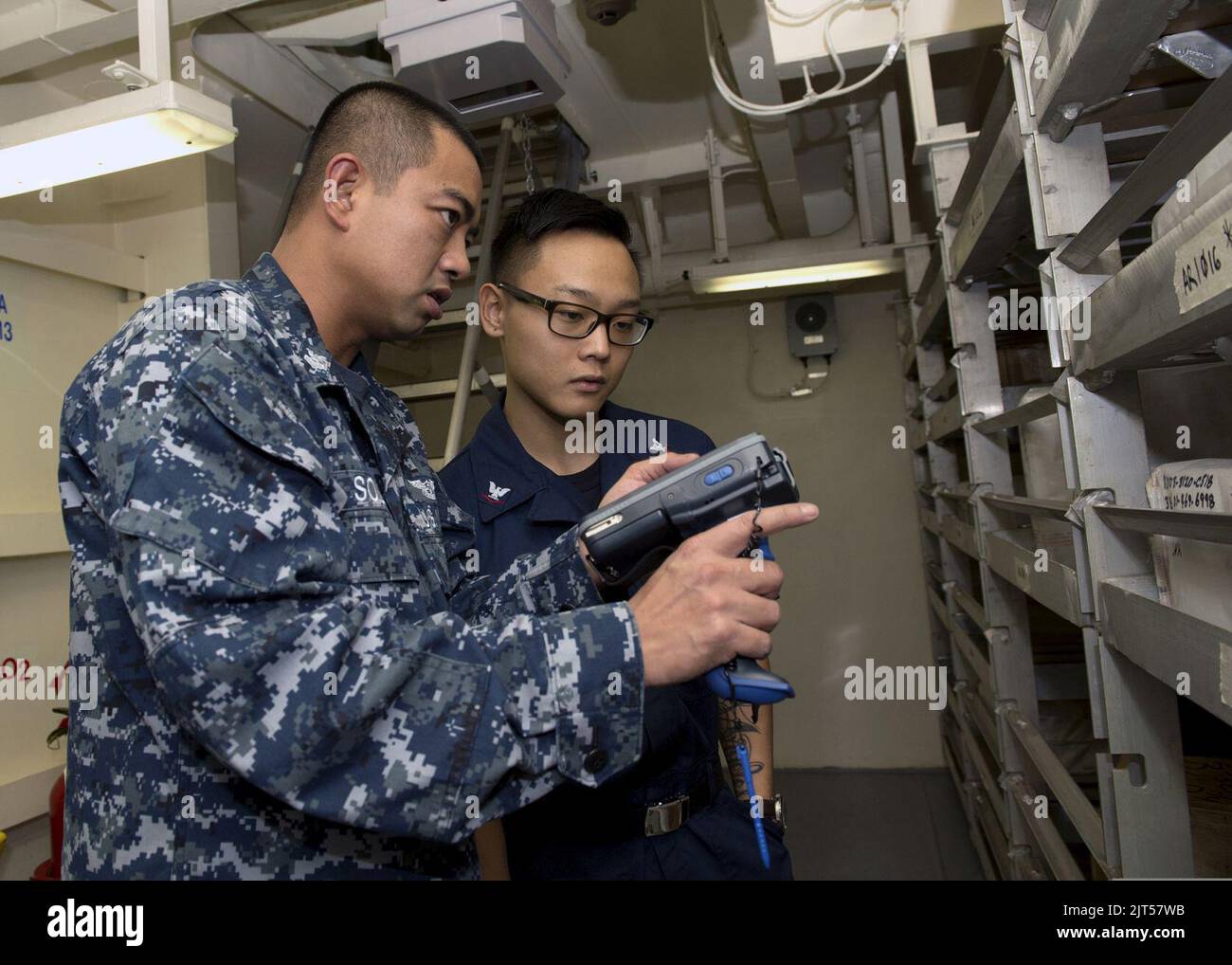 U.S. Navy Logistics Specialist 1st Class left, assigned to the ...