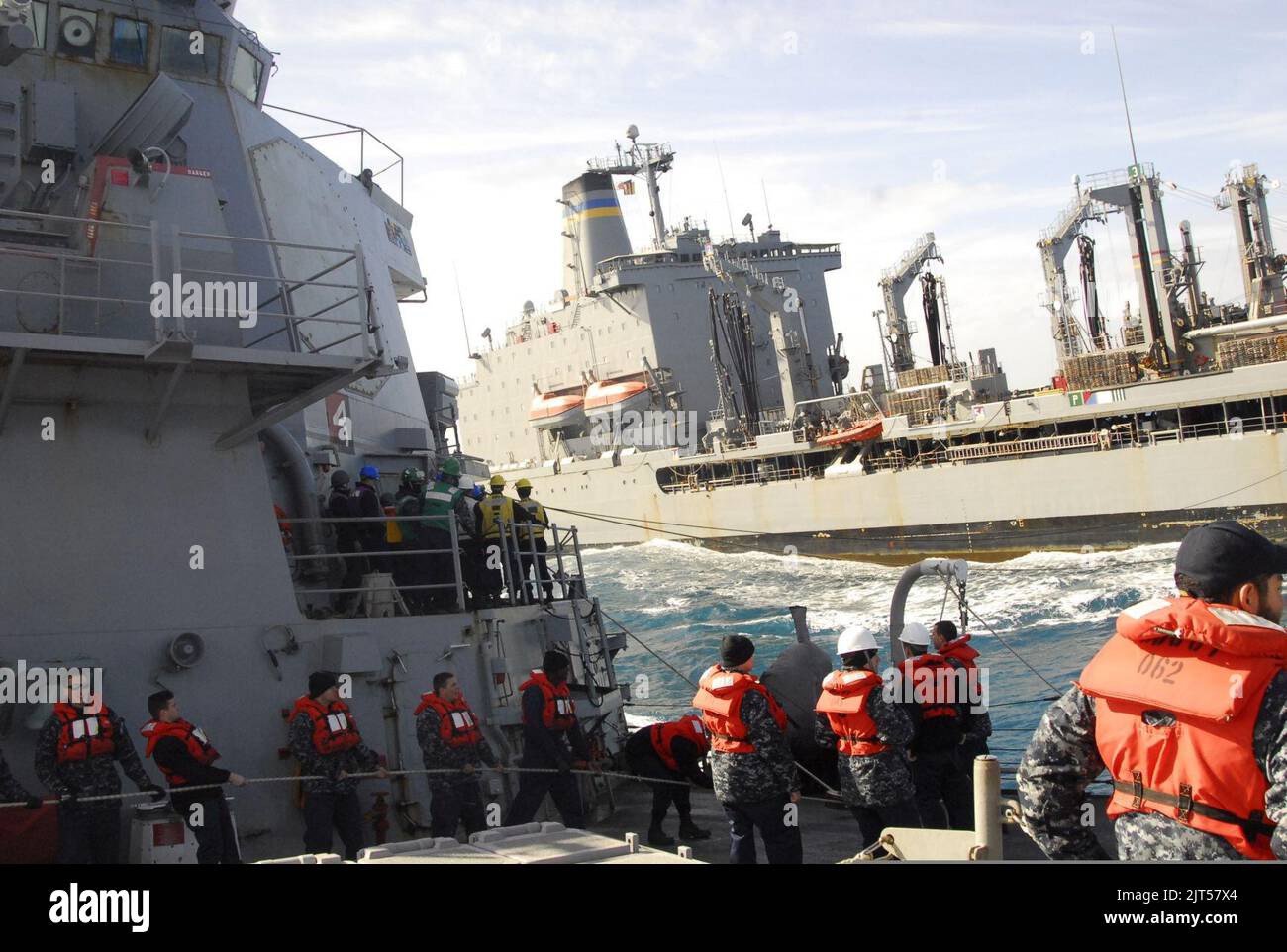 U.S. Navy line handlers aboard the guided missile destroyer USS Cole ...