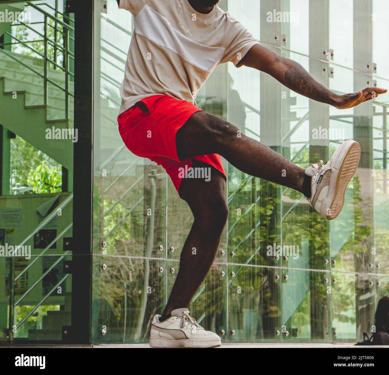 An African-American male wearing a casual outfit while doing a silly ...