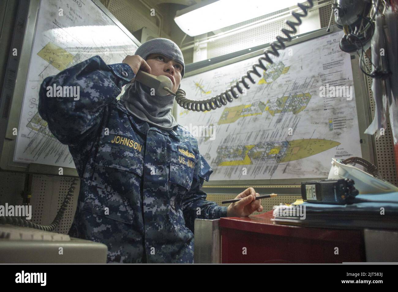 U.S. Navy Lt. j.g. a drill locker officer, communicates with scene ...