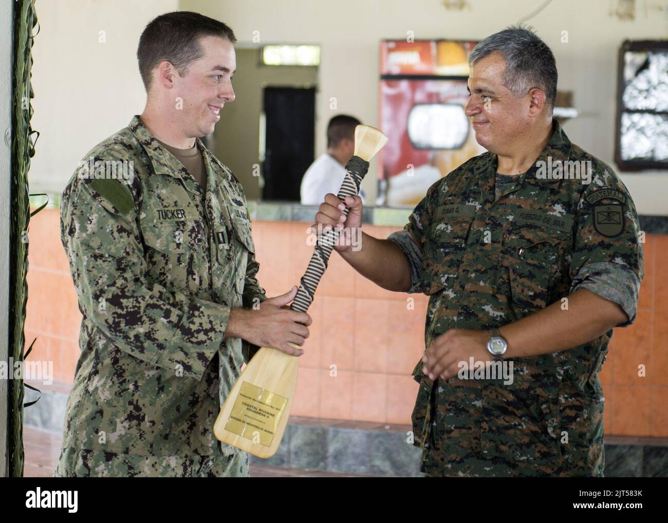 U.S. Navy Lt. left, assigned to Coastal Riverine Squadron 2, gives a ...