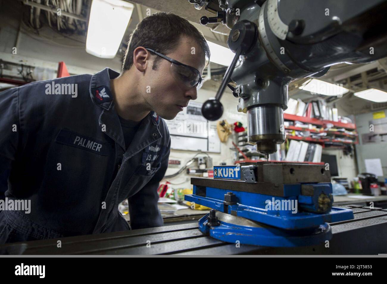 U.S. Navy Machinery Repairman 2nd Class fabricates a lock hasp in the ...
