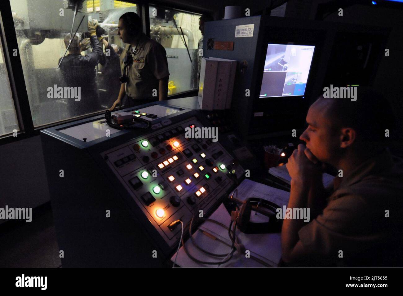 U.S. Navy Machinist's Mate 1st Class right, monitors the instructor ...