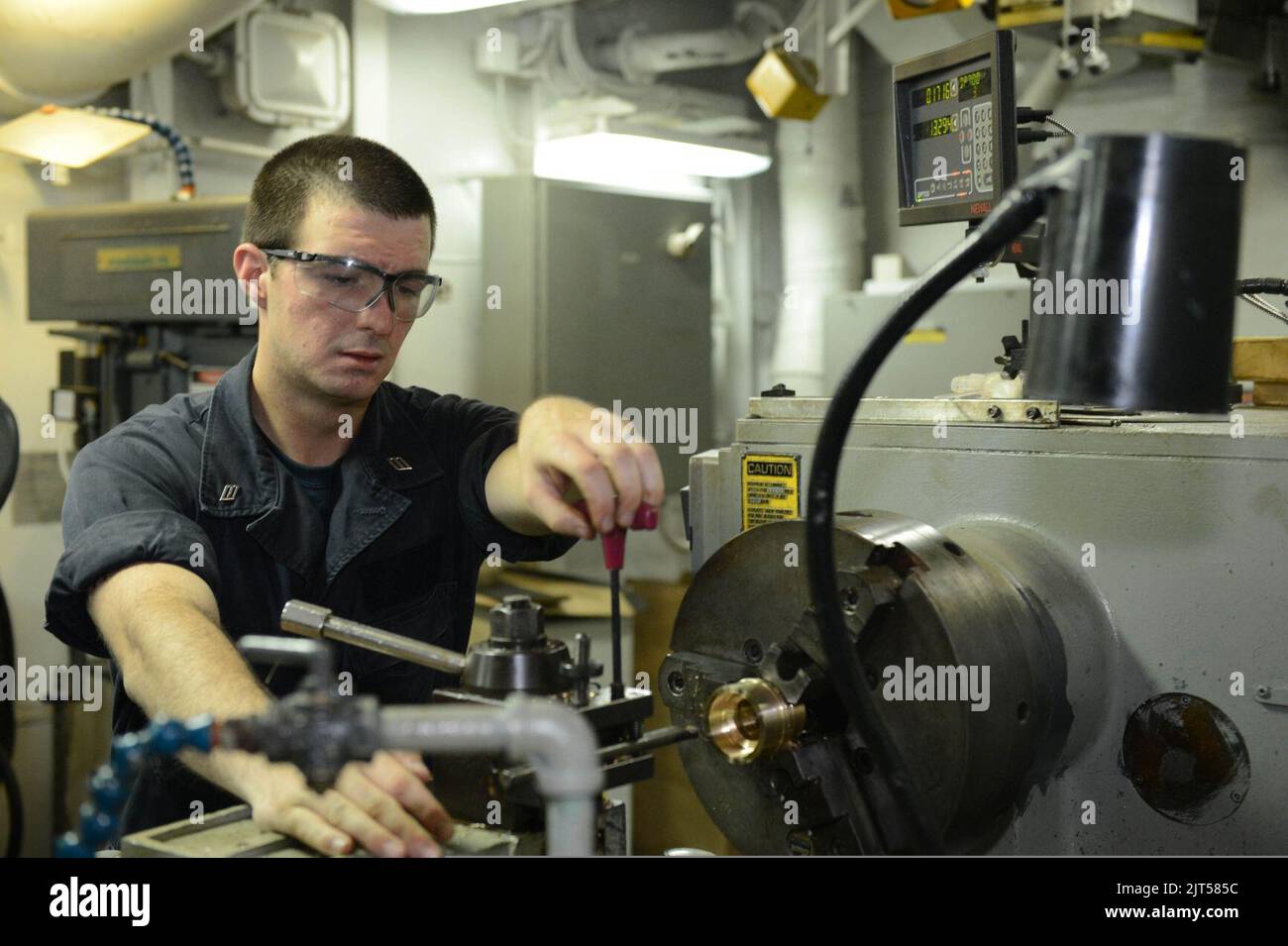 U.S. Navy Machinery Repairman Fireman works on the amphibious assault ...