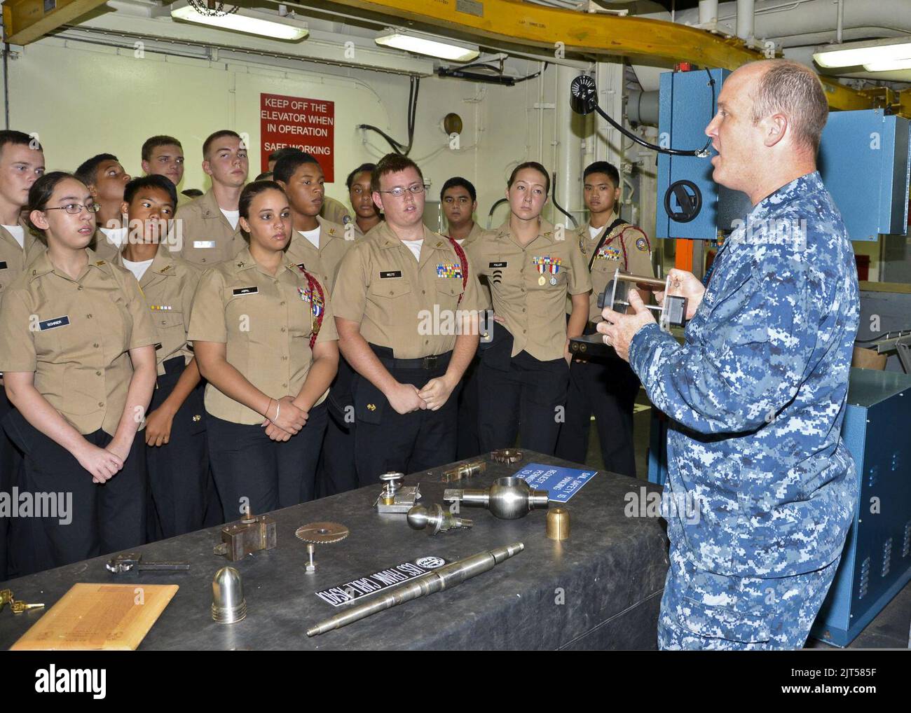 U.S. Navy Machinery Repairman 1st Class right, assigned to the ...