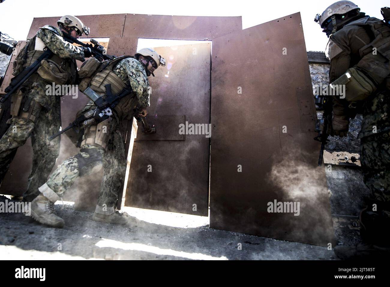 U.S. Navy Mass Communication Specialist 1st Class busts open a door ...