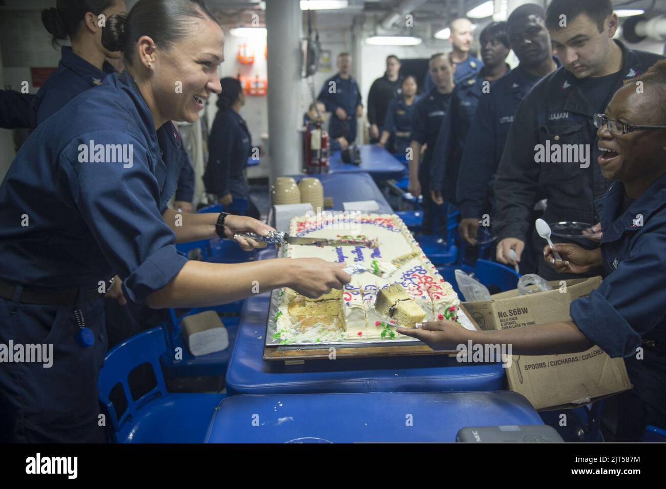 U.S. Navy Master-at-Arms 1st Class left, serves cake to Boatswain's ...