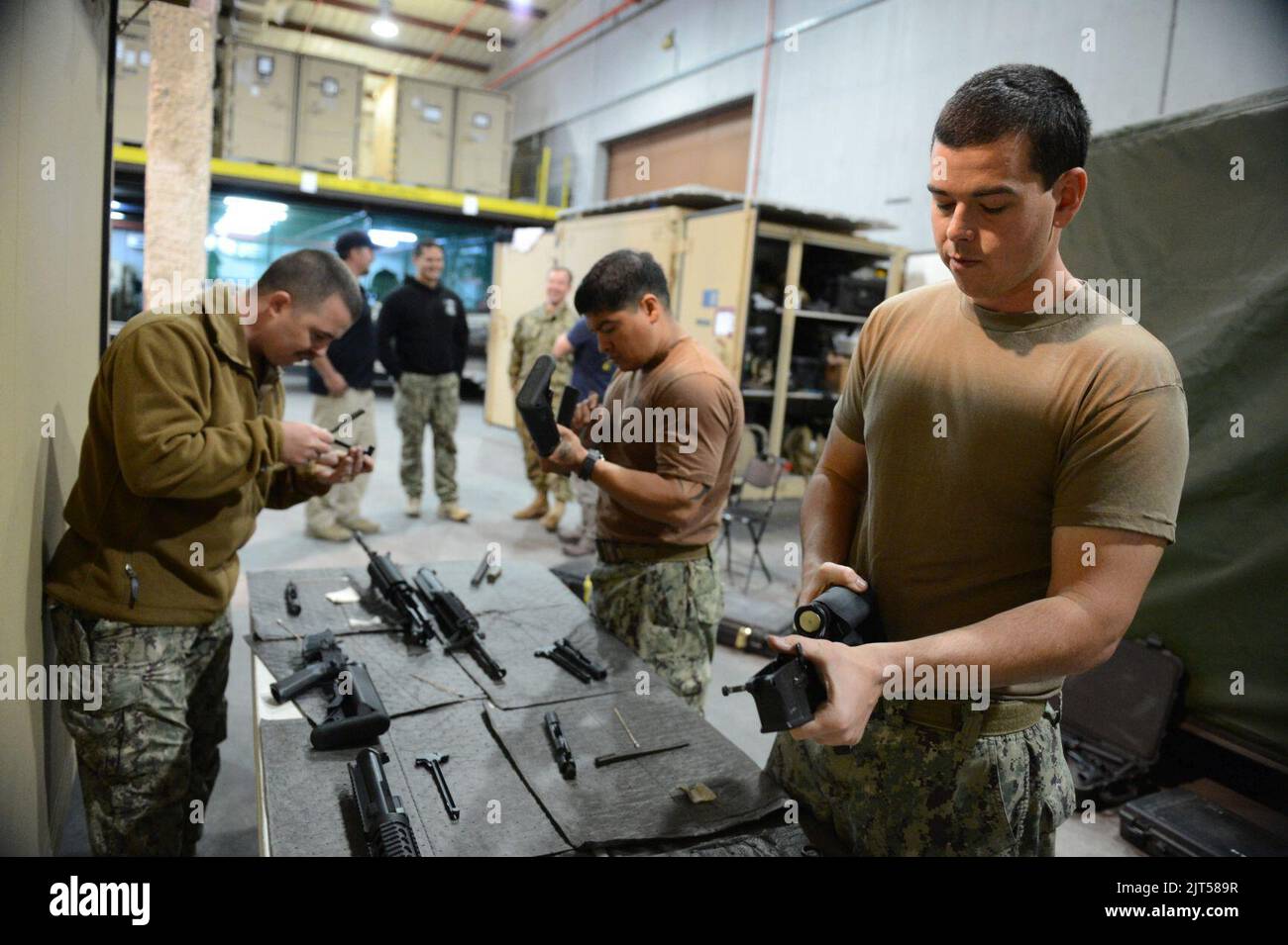 U.S. Navy Mineman 1st Class right, assigned to Commander, Task Force ...