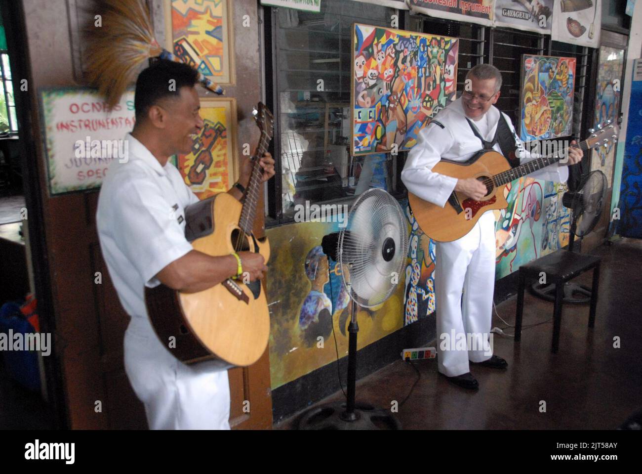 U.S. Navy Musician 1st Class right, assigned to the U.S. Navy 7th Fleet ...