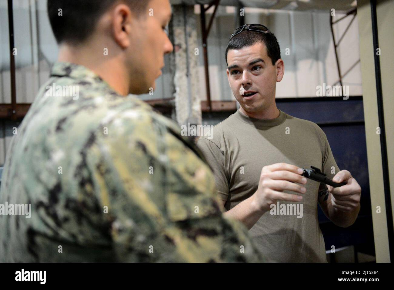 U.S. Navy Mineman 1st Class right, assigned to Commander, Task Force ...