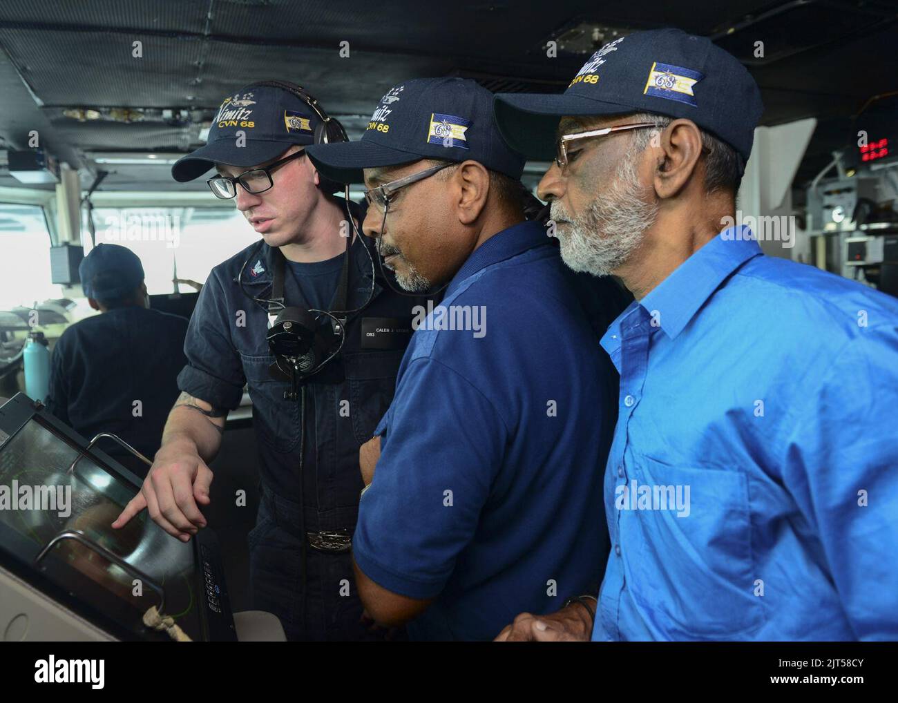 U.S. Navy Operations Specialist 3rd Class explains a bridge watch to ...