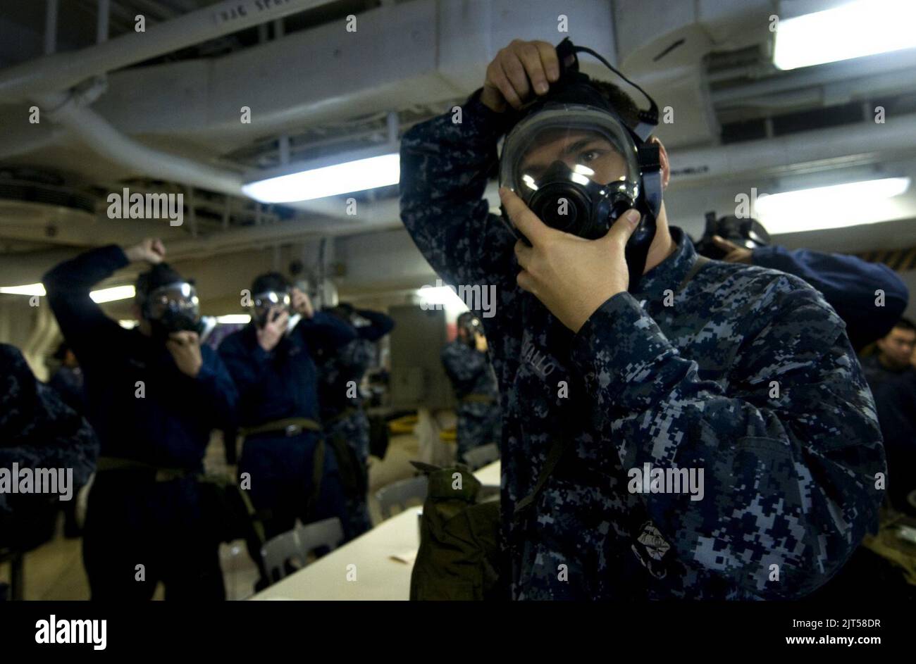 U.S. Navy Personnel Specialist 3rd Class dons his chemical, biological ...