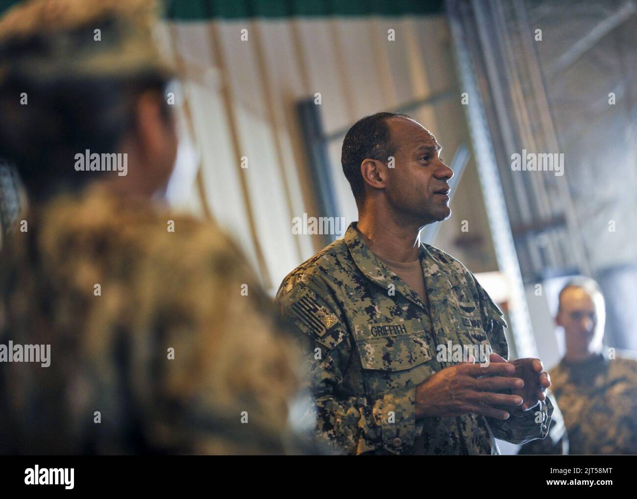 U.S. Navy Rear Adm. Vincent Griffith, center, the commander of Naval ...