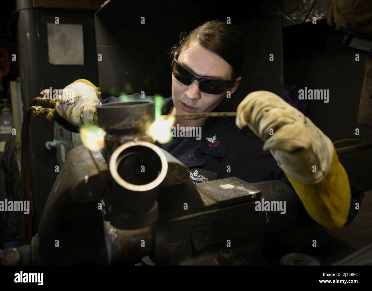 U.S. Navy Sailor welds pipe aboard aircraft carrier. (39517735881 Stock ...