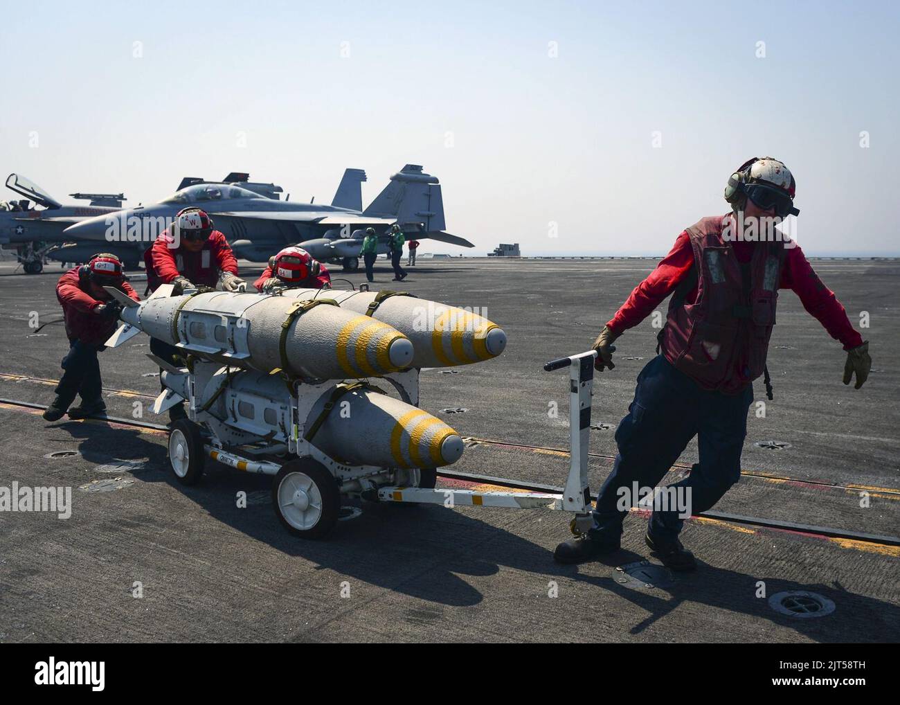 U.S. Navy Sailors move ordnance aboard USS Nimitz in the Arabian Gulf ...
