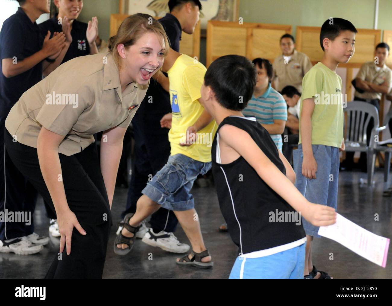 U.S. Navy Seaman Apprentice (left), assigned to the U.S. 7th Fleet ...