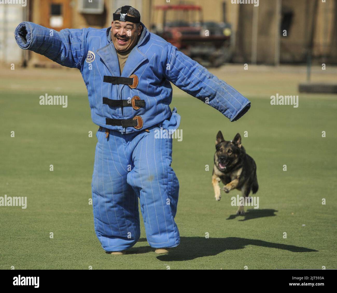 U.S. Navy Senior Chief Yeoman runs away from Axel, a German shepherd ...
