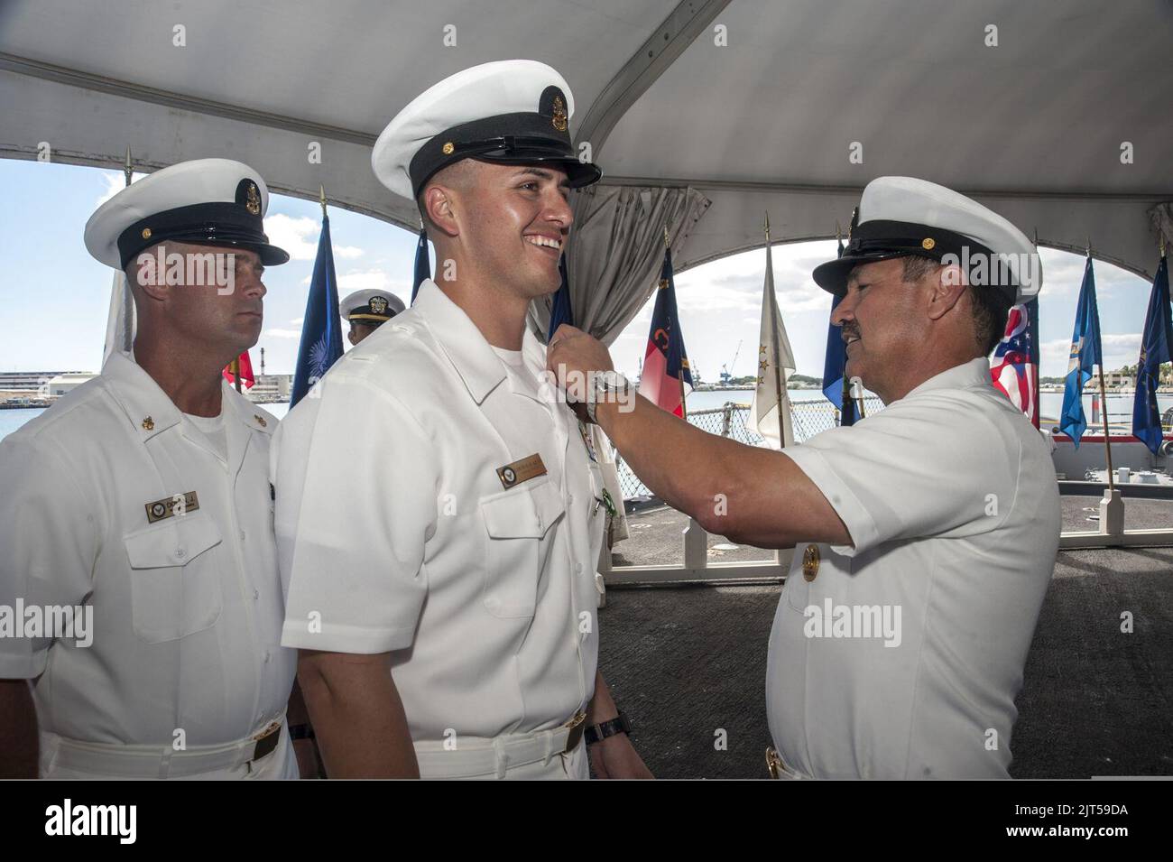 U.S. Pacific Fleet Master Chief right, removes the anchors from Chief ...