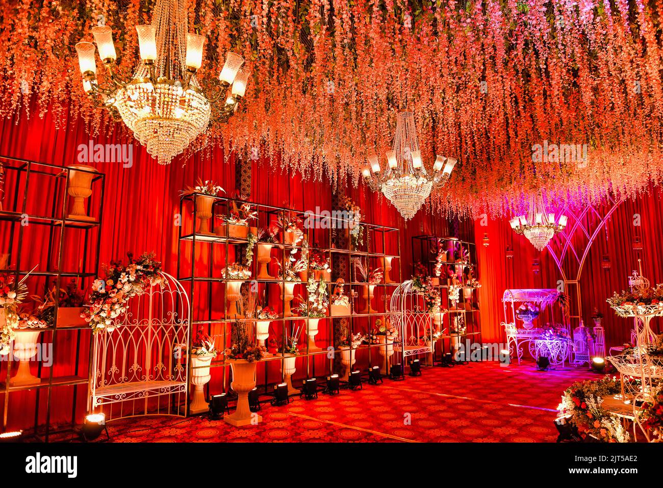 A beautiful Indian wedding setup with stage decorations and flowers ...
