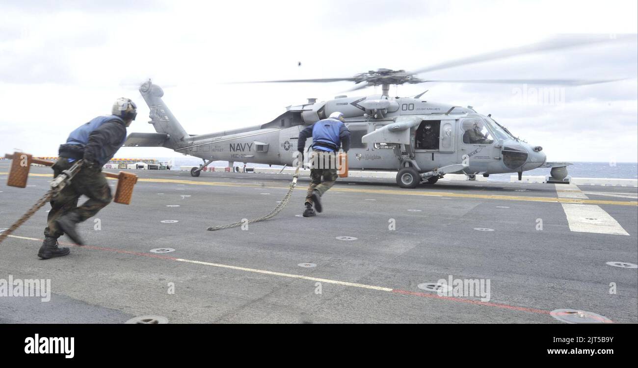 U.S. Sailors aboard the amphibious assault ship USS Bataan (LHD 5) run ...