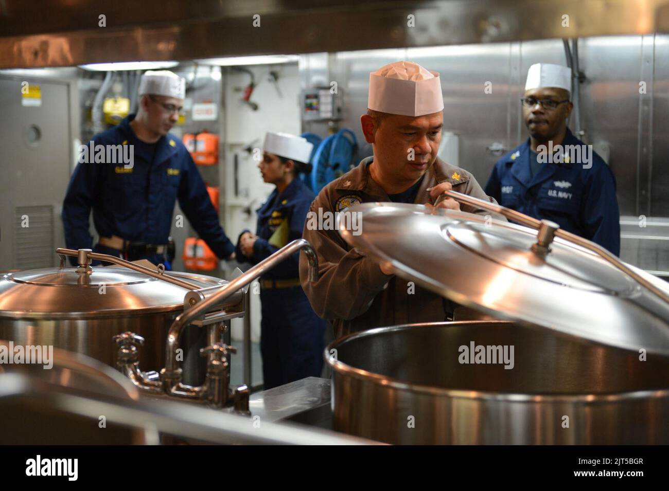 U.S. Sailors accompany a member of the Board of Inspection and Survey ...