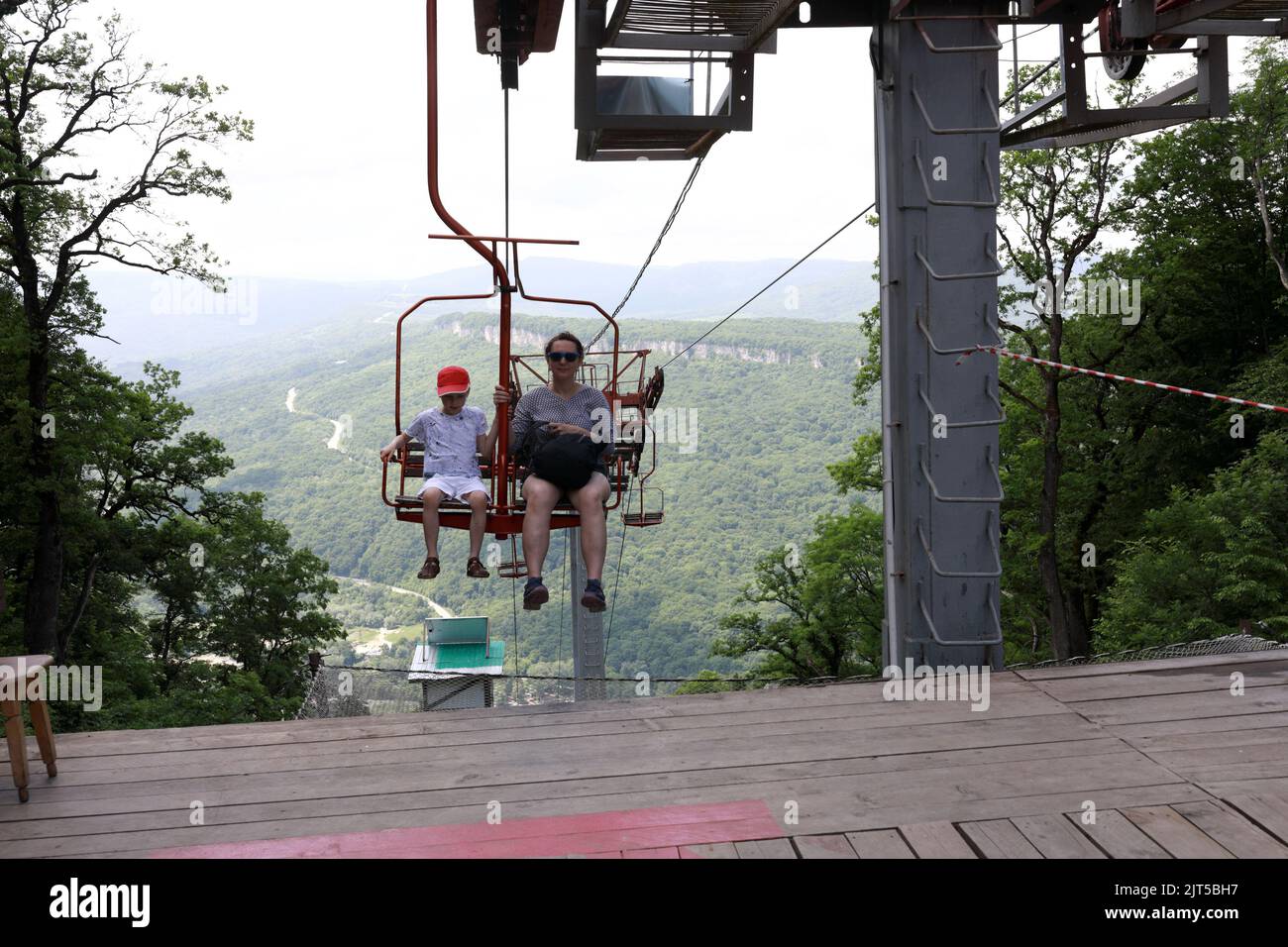 Mother and her son in chair of Savran cable car, Adygea Stock Photo - Alamy