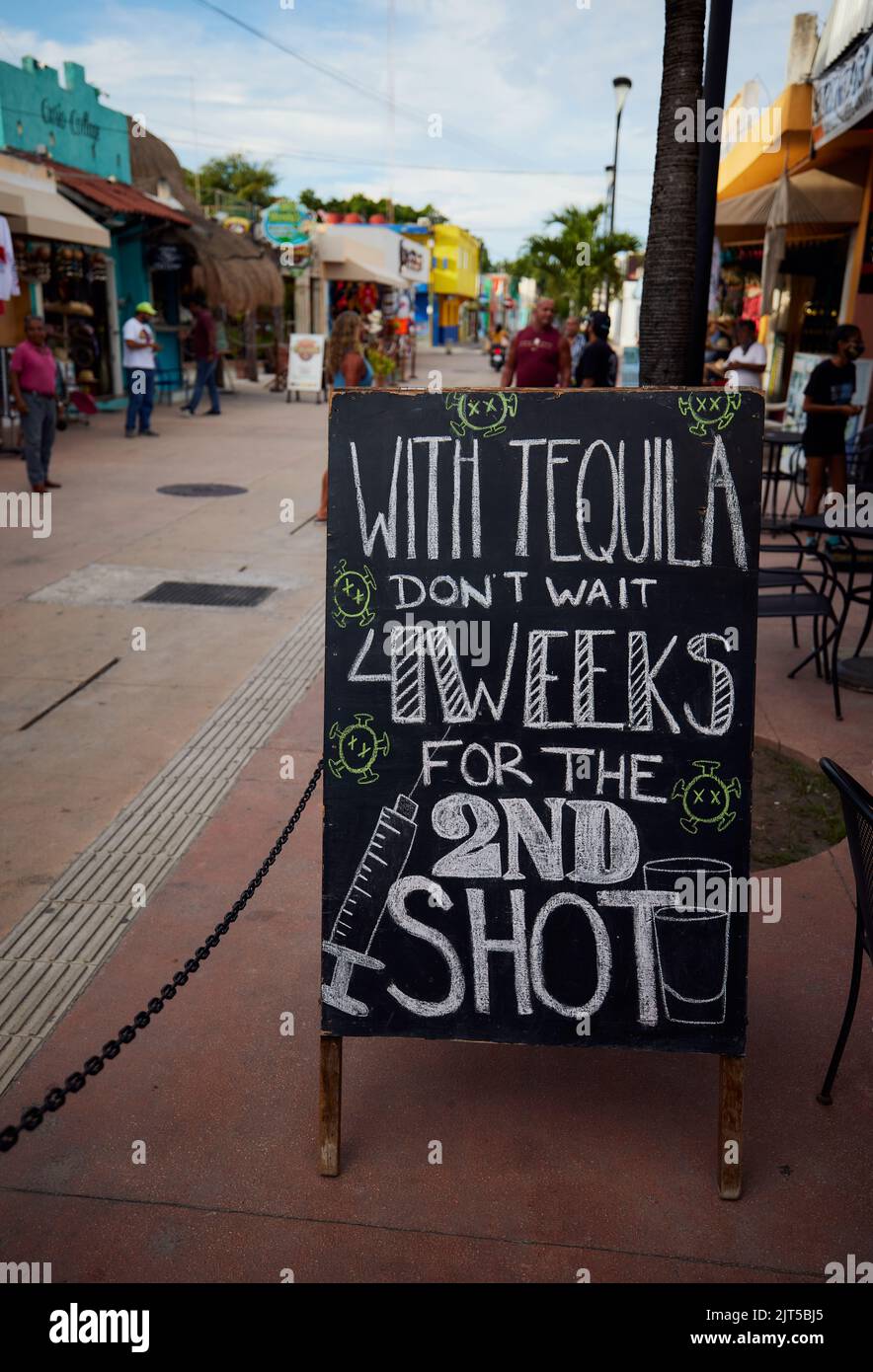 A blackboard street sign of a bar "With tequila don't wait 4 weeks for ...