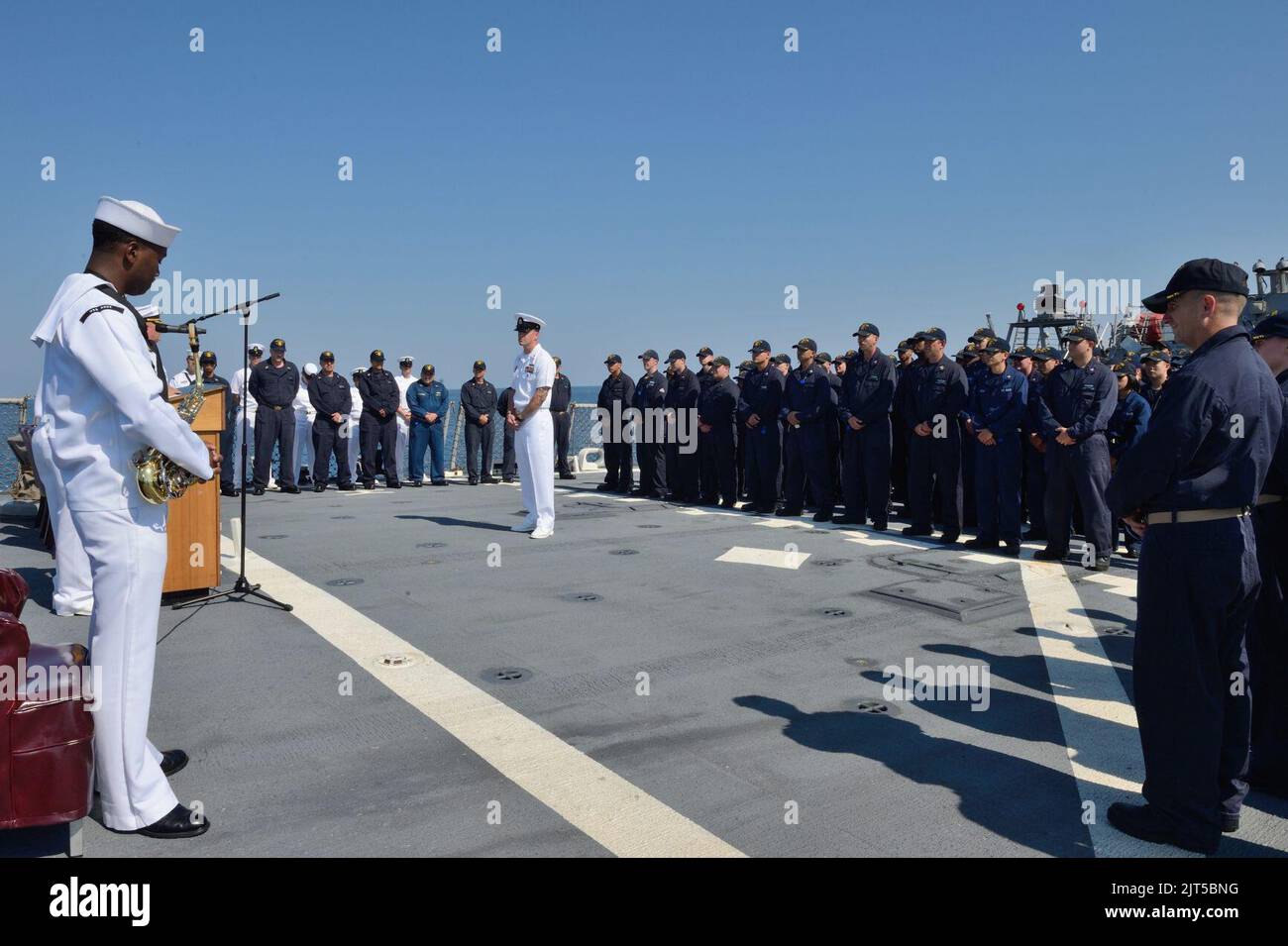 U.S. Sailors assemble on the fantail aboard the guided missile ...