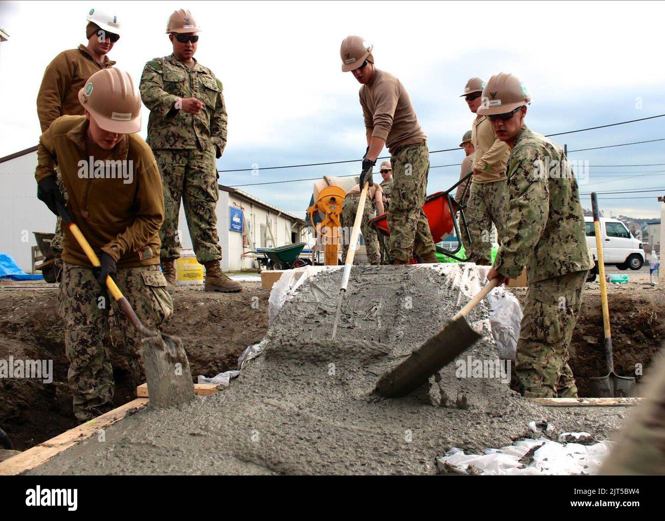 U.S. Sailors assigned to Naval Mobile Construction Battalion 3 place ...
