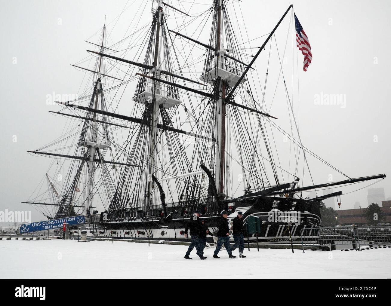 U.S. Sailors assigned to the USS Constitution walk near the ship's ...