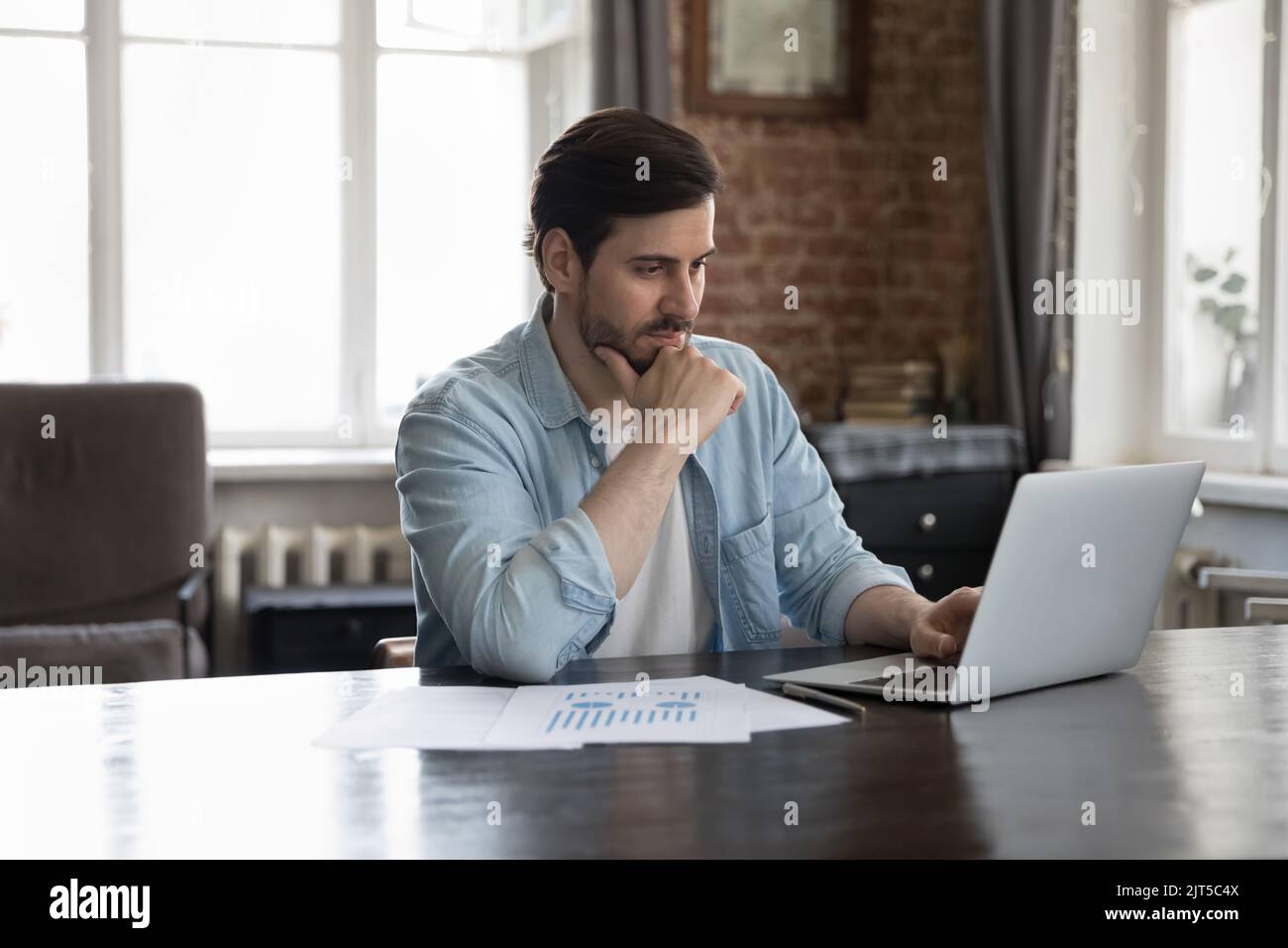 Pensive thoughtful business marketing professional man using laptop ...